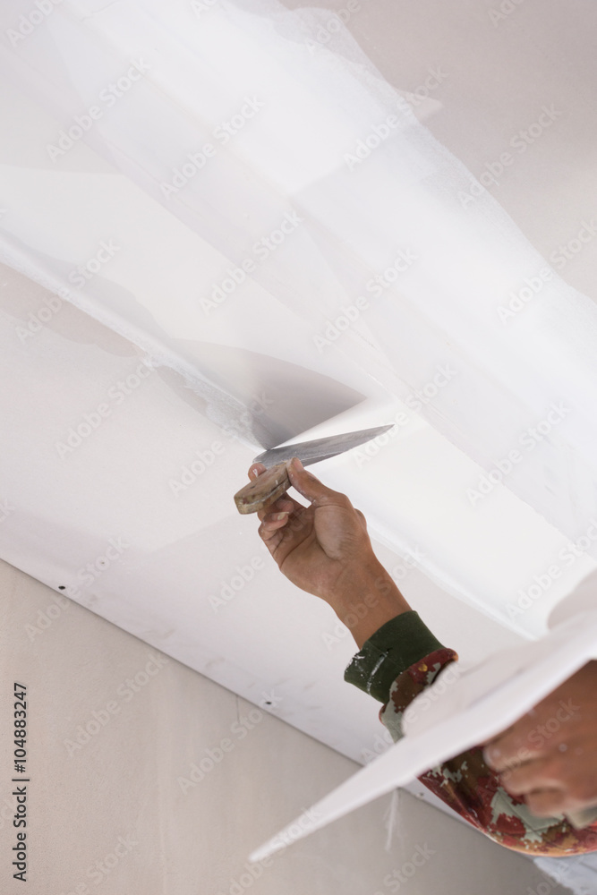 hand of worker using gypsum plaster ceiling joints Stock Photo | Adobe ...