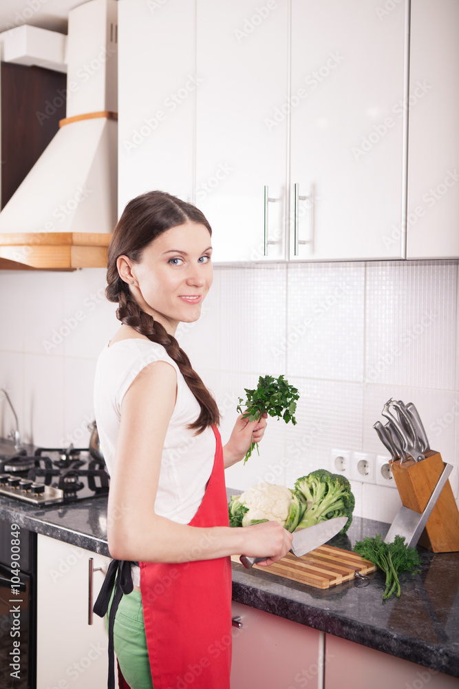 Smiling woman making healthy food in kitchen. Stock Photo | Adobe Stock