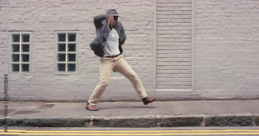Young man in fedora dancing freestyle in city Stock Video | Adobe Stock