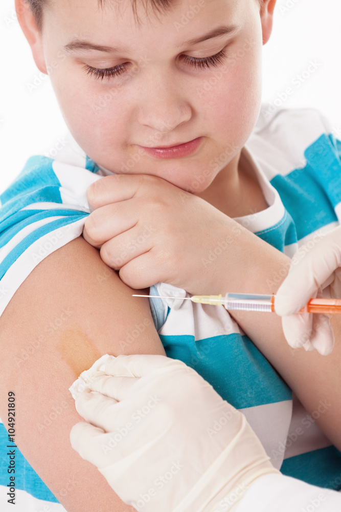 Doctor giving a child injection in arm on isolated image. Stock Photo ...