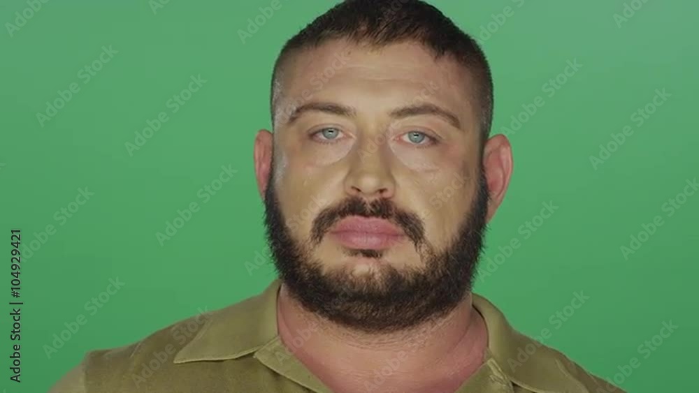 Muscular man blankly staring, on a green screen studio background Stock ...