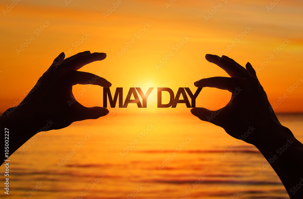 Silhouette, Close up Hand holding MAY DAY text with blurred sea sunset ...