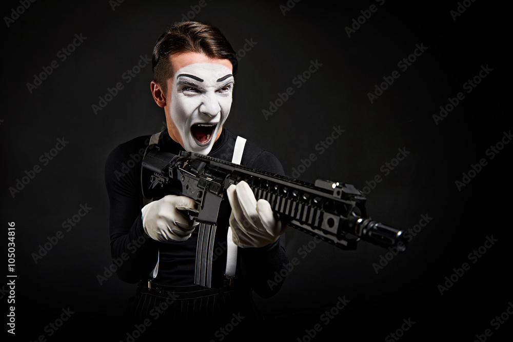 Crazy mime with weapon/Crazy smiling and screaming mime with rifle in ...