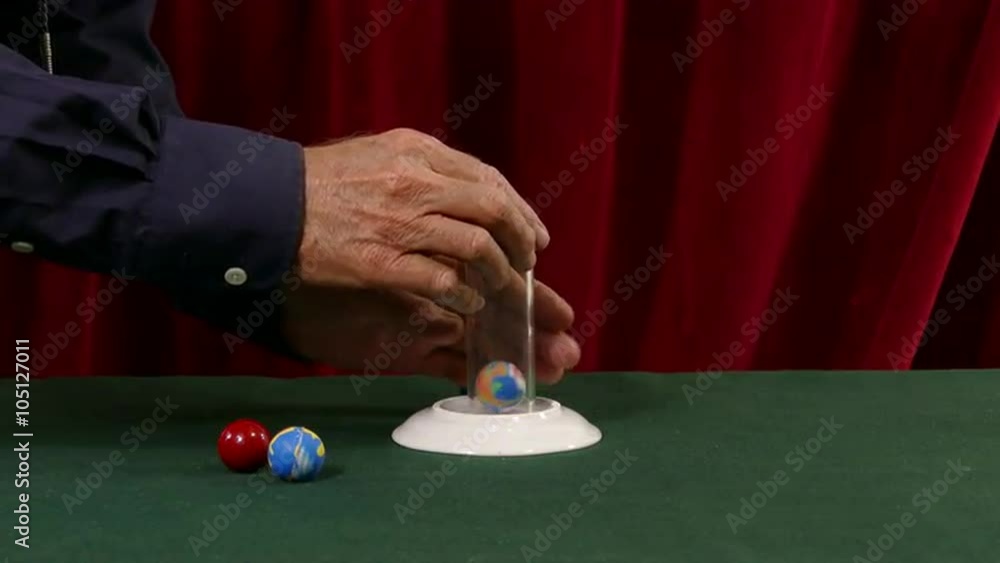 Magician performs the Red Ball magic trick. Stock Video | Adobe Stock