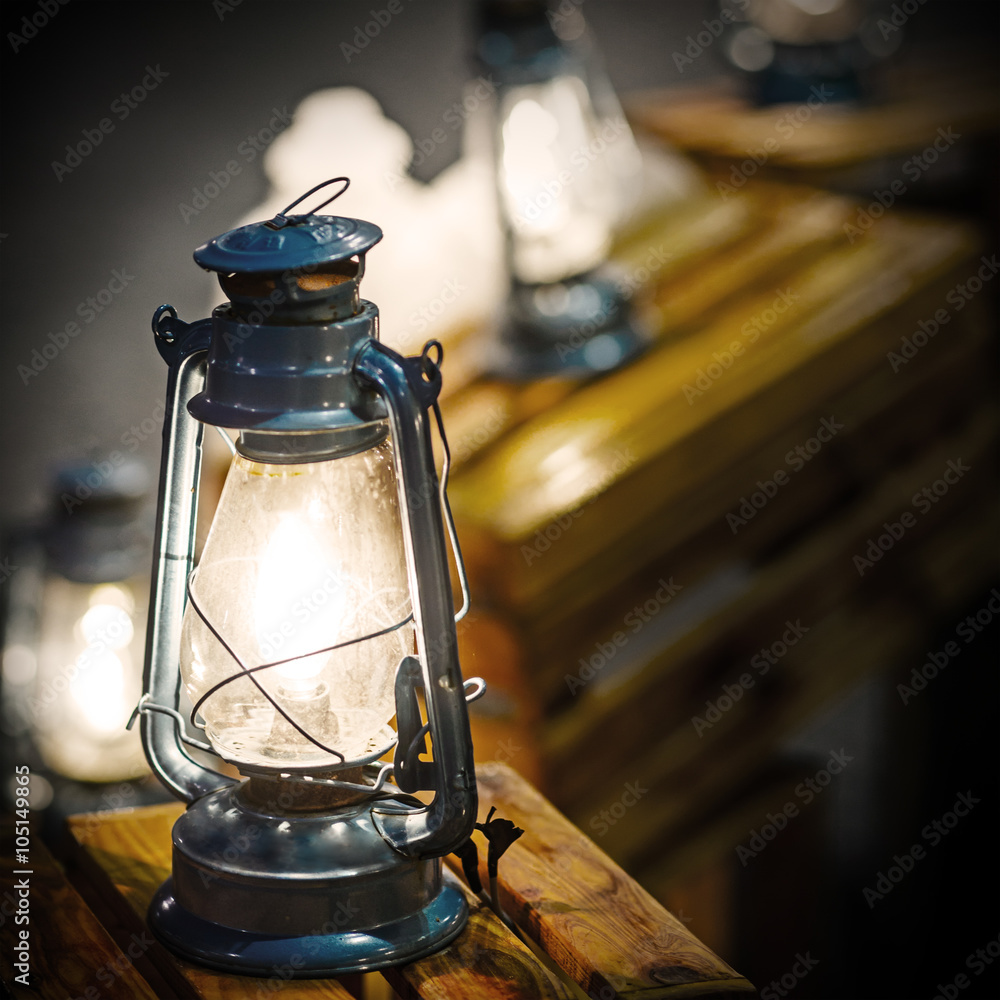 Vintage fashioned rustic kerosene oil lantern lamp burning with a soft ...