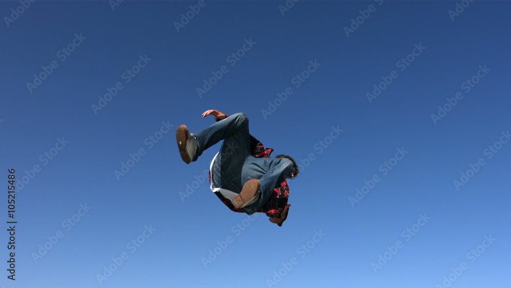 Teen boy flips in sky, slow motion Stock Video | Adobe Stock