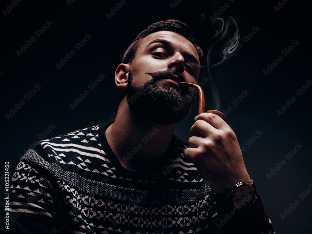 Confident macho man smoking pipe and showing off his moustache and ...