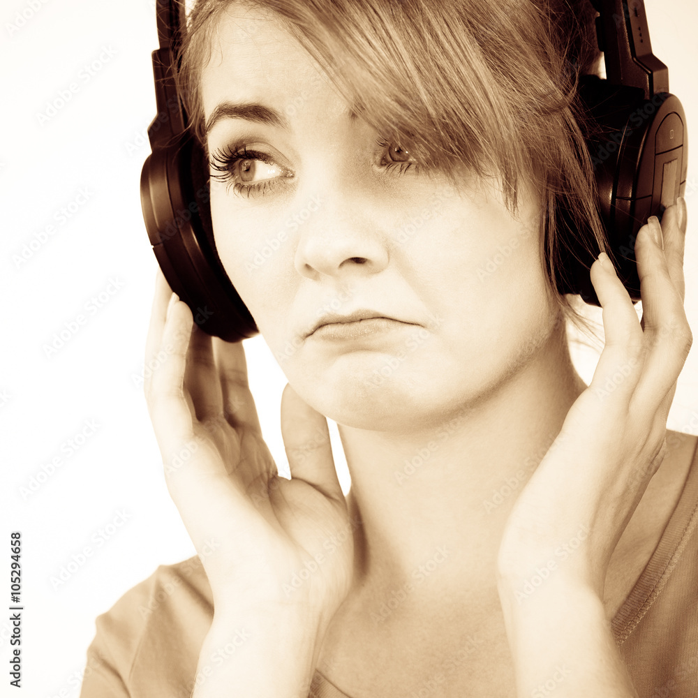 Woman sad girl in big headphones listening music Stock Photo | Adobe Stock
