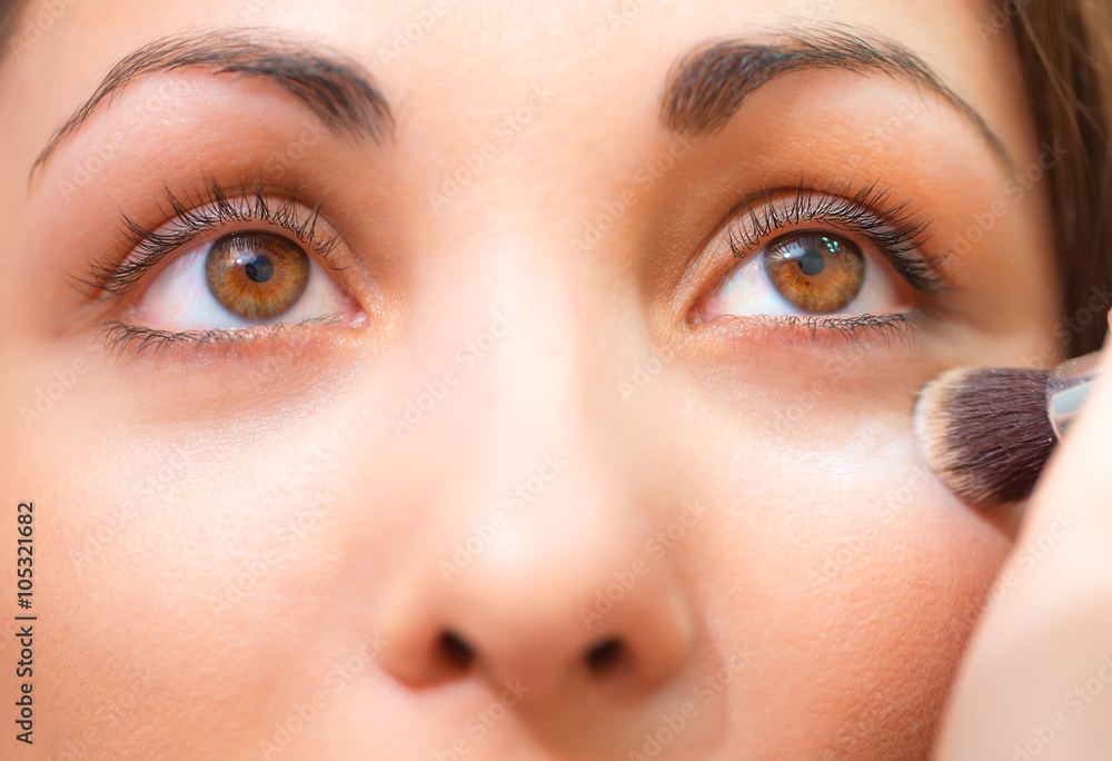 Applying face powder on a beautiful girls face. Stock Photo | Adobe Stock