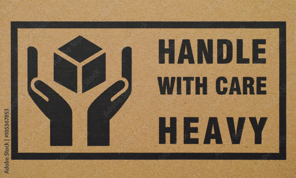Sign Handle with care Heavy on cardboard box Stock Photo | Adobe Stock