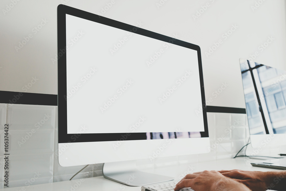 Mock up of generic design computer and workspace with man hands. Horizontal mockup, blank screen ...