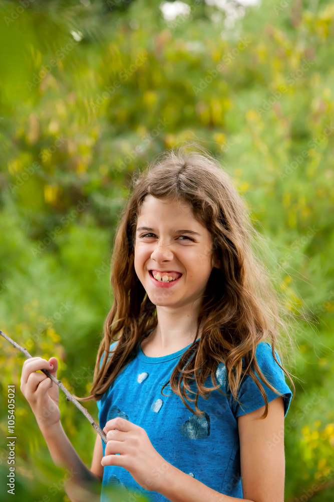 Laughing Tween Girl with Messy Hair Holding a Stick Stock Photo | Adobe ...
