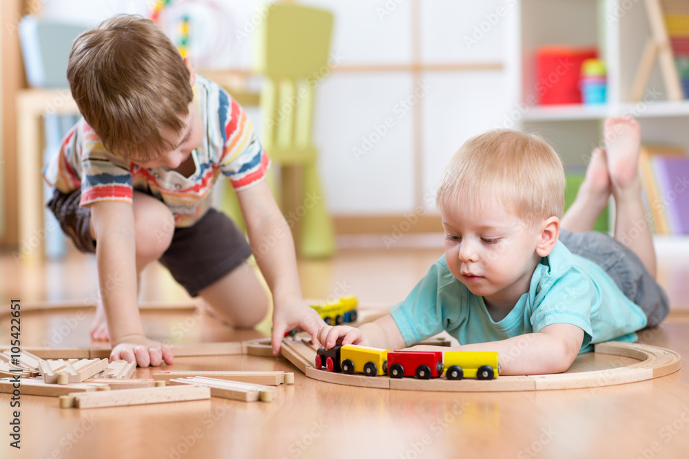 Cute children playing with wooden train. Toddler kids play with blocks ...