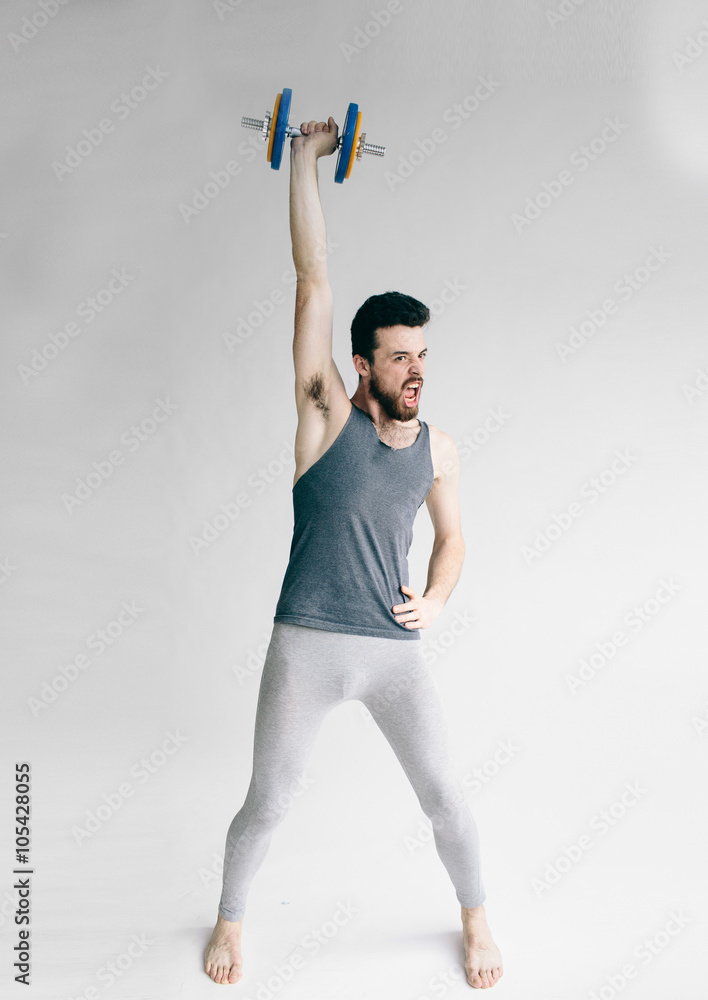 Skinny man training his bicep muscle. Stock Photo | Adobe Stock