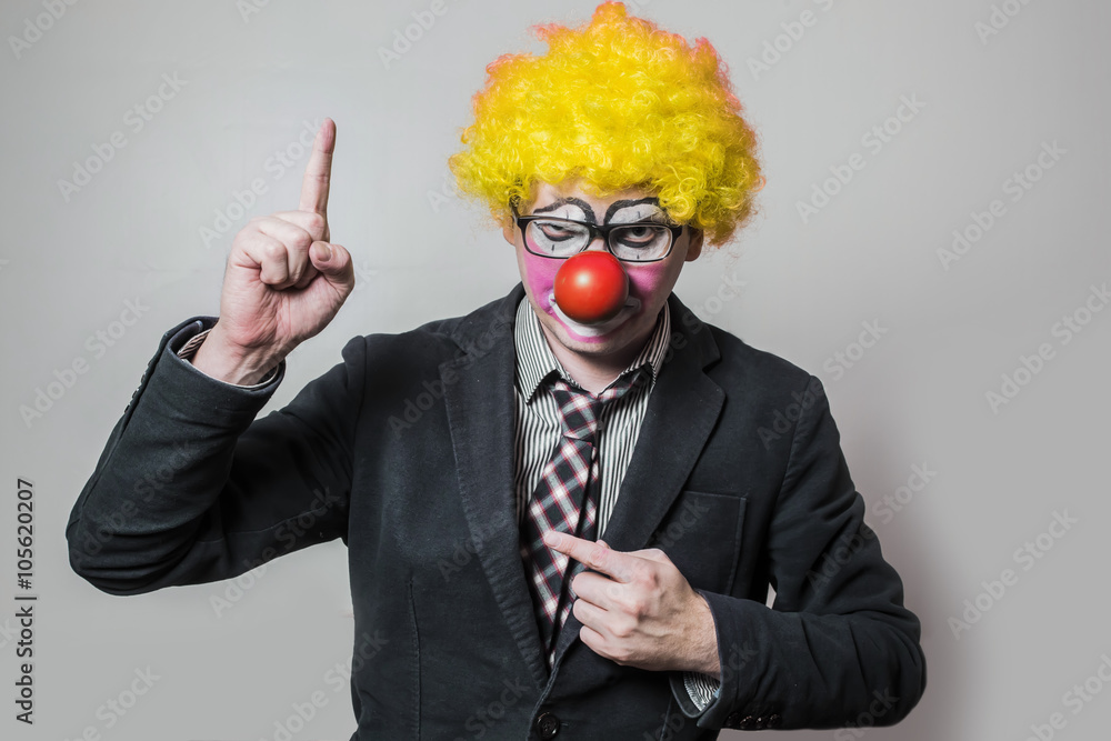 clown, with his finger raised to the top as a gesture of attracting ...