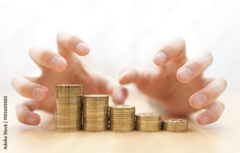Greed for money. Hands grabbing coins. Stock Photo | Adobe Stock