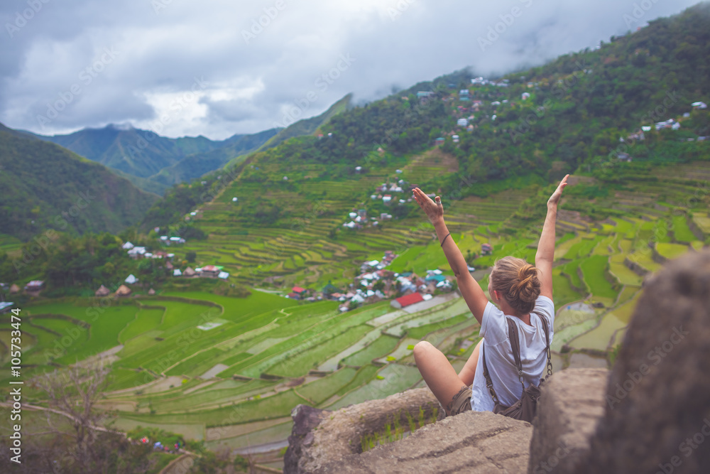Freedom, travel,success concept.Woman sitting on rice terrace looking ...