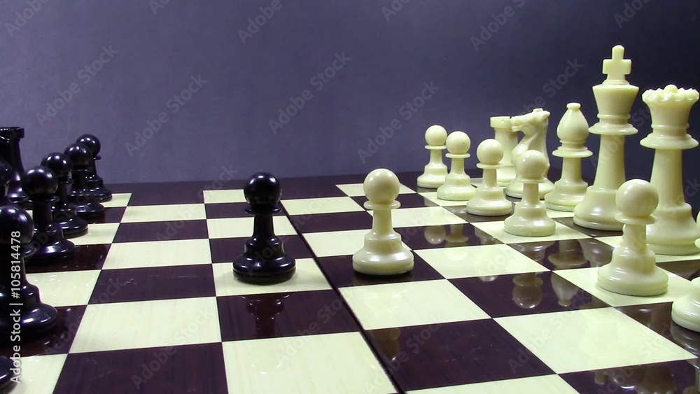 Chess board with pieces arranged at the beginning of a game , and ...