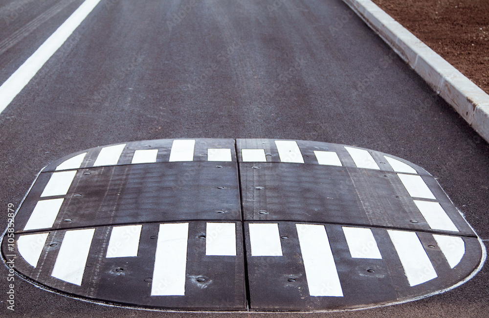 Road speed bump on the asphalt Stock Photo | Adobe Stock