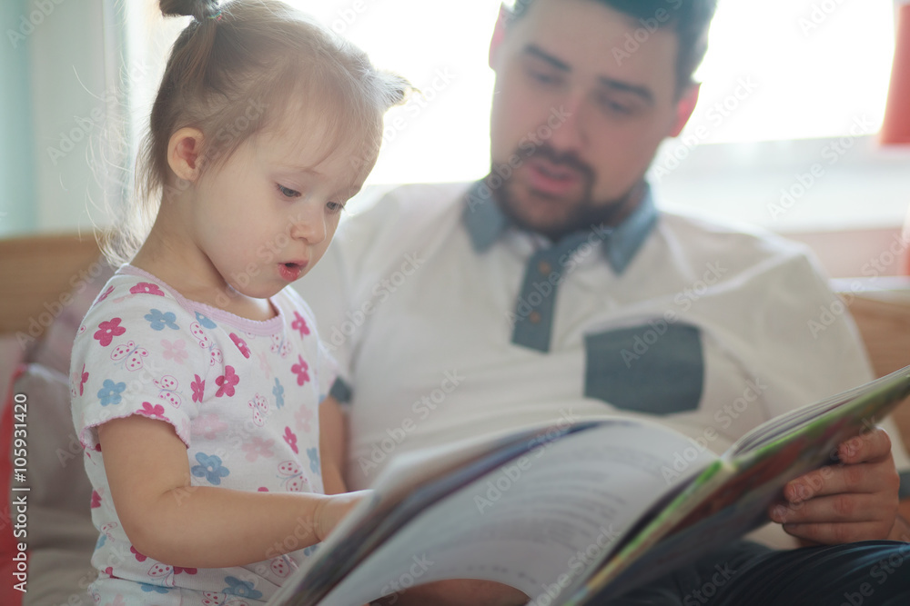 Dad and daughter reading a book Stock Photo | Adobe Stock