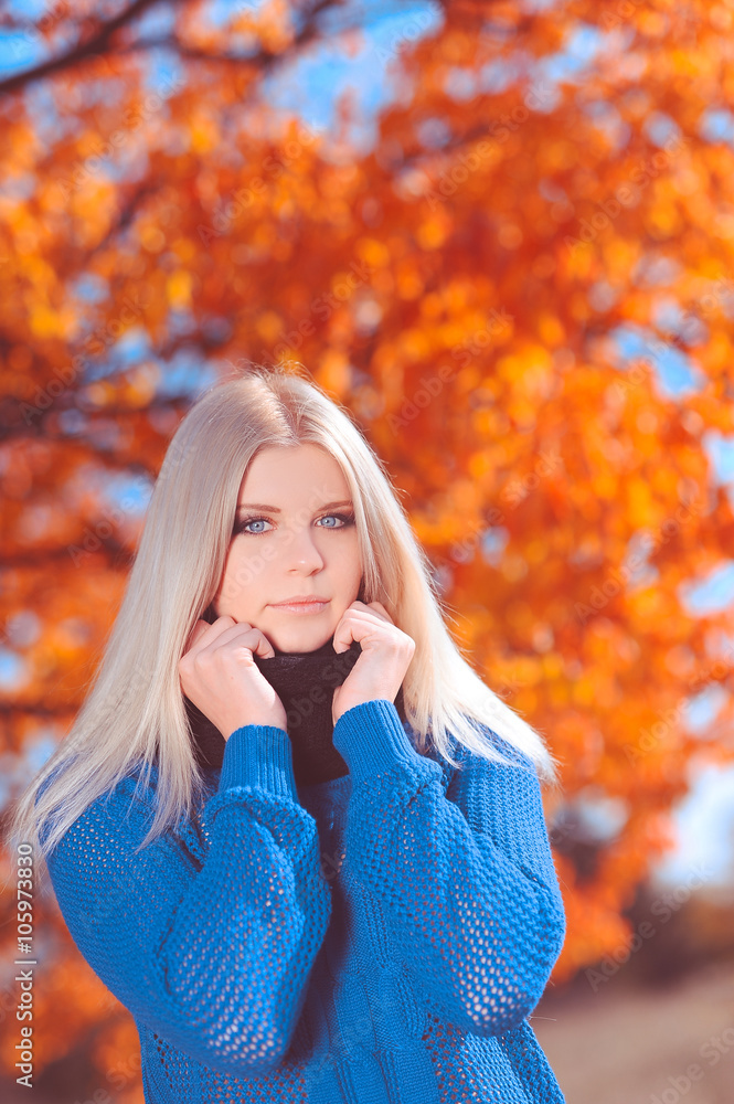 Beautiful girl 20-24 year old wearing blue sweater at autumn background ...