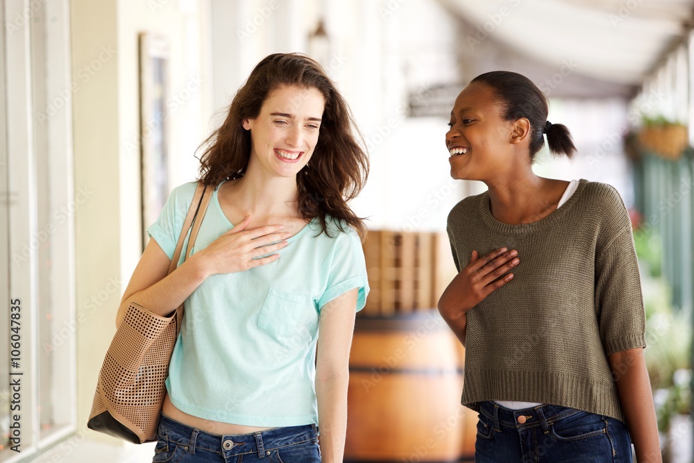 Smiling friends walking together Stock Photo | Adobe Stock