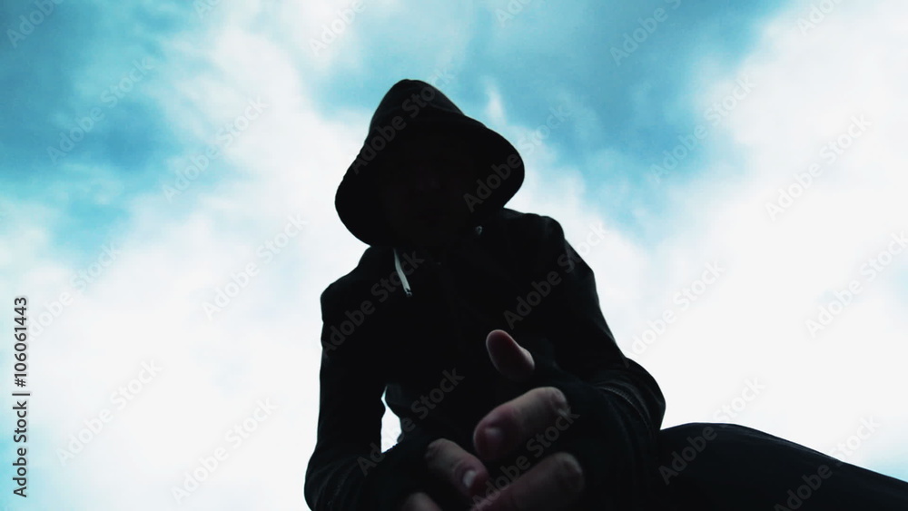 Violent attack, unrecognizable hooded male criminal kicking and ...