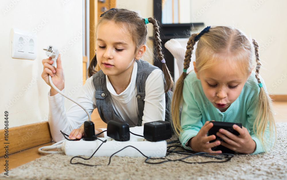 children playing with sockets and electricity indoors Stock Photo ...