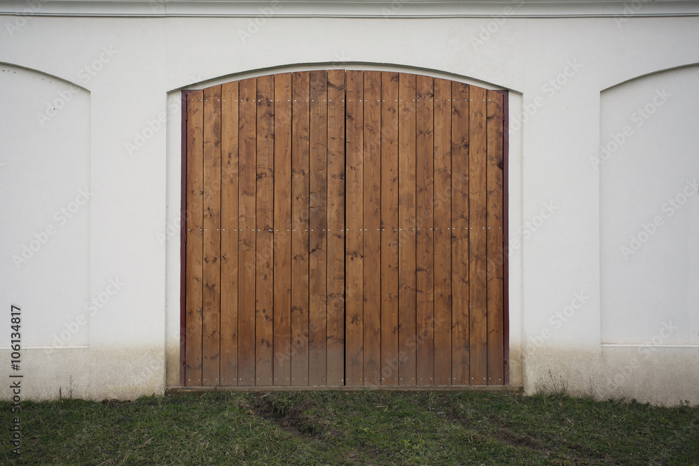 Big wooden barn gate. Monumental farm door, two timber leaf, closed ...