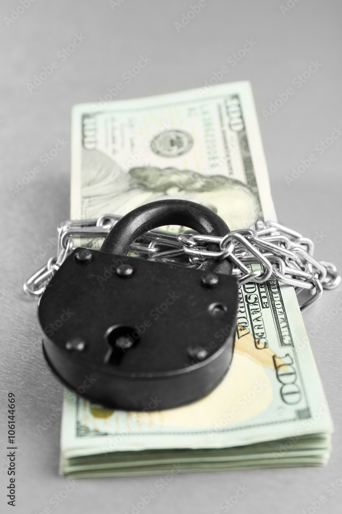 Dollars currency with lock and chain on grey background Stock Photo ...