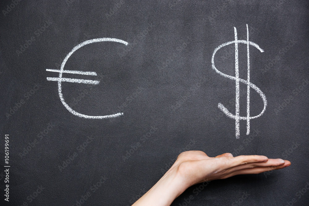 Hand showing signs of dollar and euro drawn on blackboard Stock Photo ...