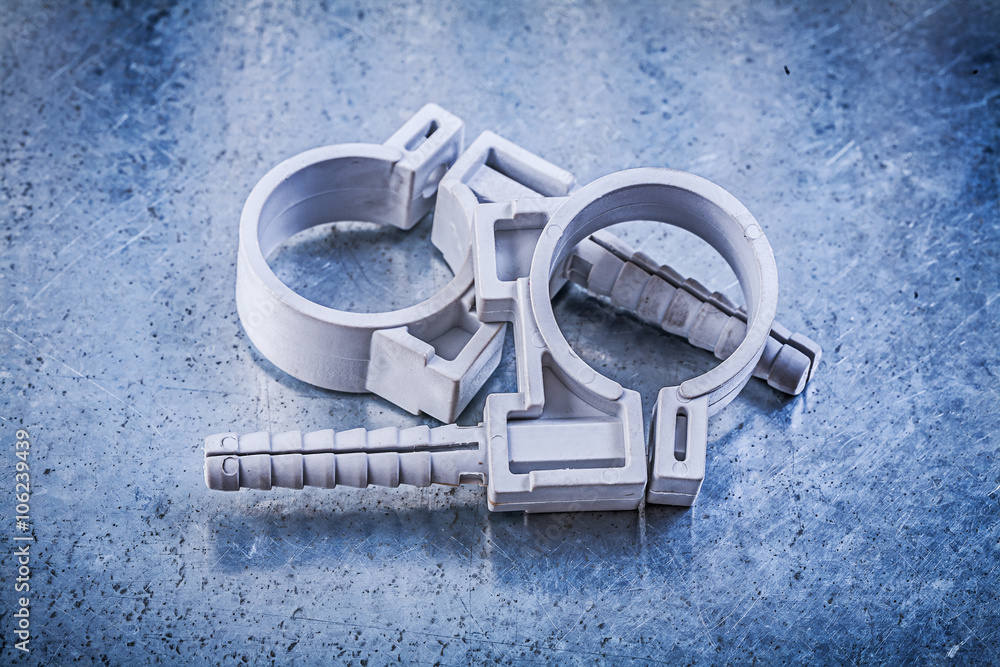 Pvc pipe clamps on metallic background construction concept Stock Photo ...