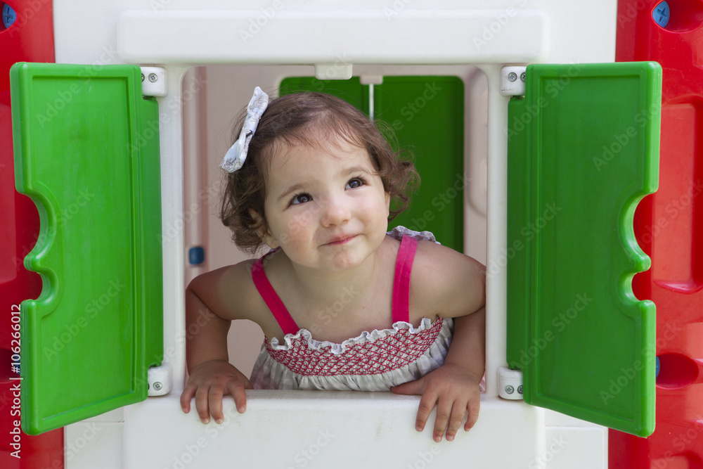 Poster Little girl smiling through the window of kids playhouse – Wall ...