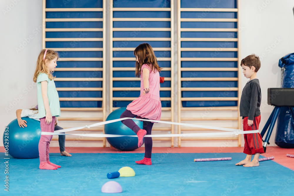 Children playing with elastic band Stock Photo | Adobe Stock