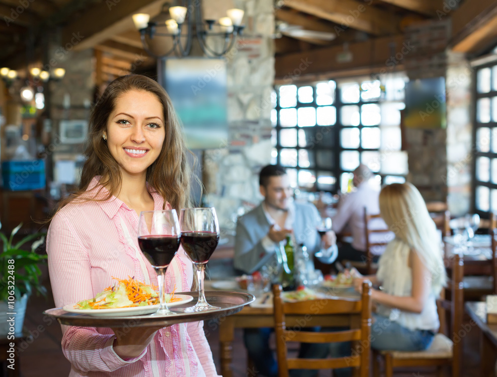 Waiter with restaurant guests at table Stock Photo | Adobe Stock