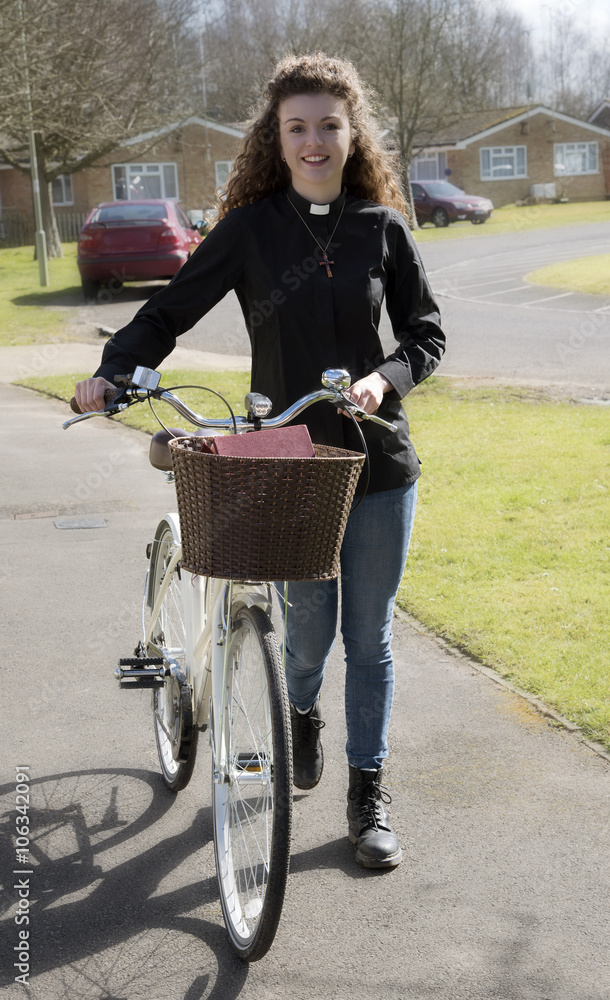 Young attractive parish priest using a bicycle as transport Stock Photo ...