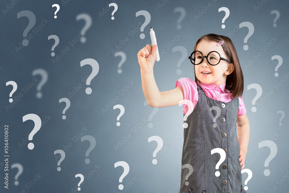 Cute little girl wearing business dress and writing question mark. Blue ...