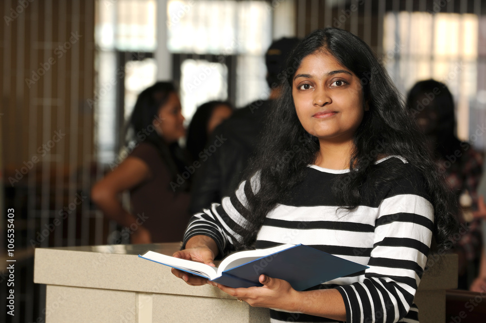 Young Indian Student Holding Book Stock Photo | Adobe Stock
