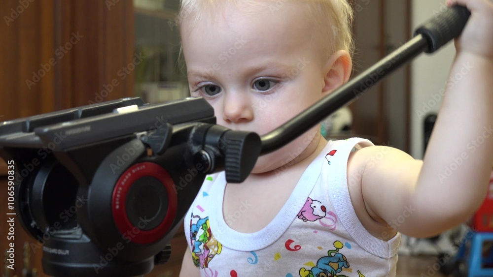 Little Child Discovering Tripod. 4K UltraHD video. Stock Video | Adobe ...