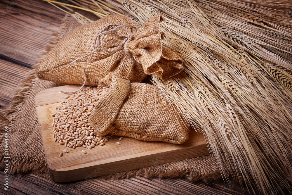 Grain in sacks and ears of wheat Stock Photo | Adobe Stock