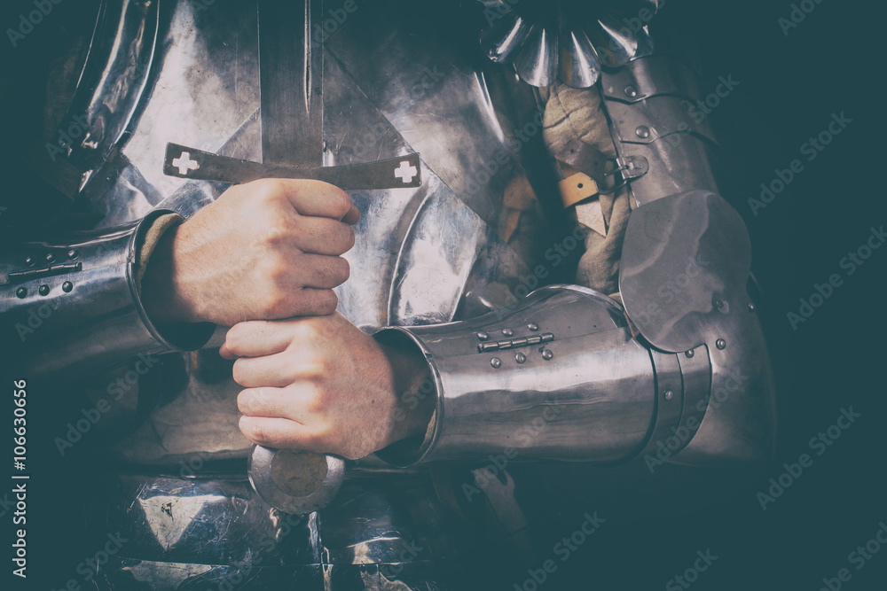 knight wearing armor and holding two-handed sword Stock Photo | Adobe Stock