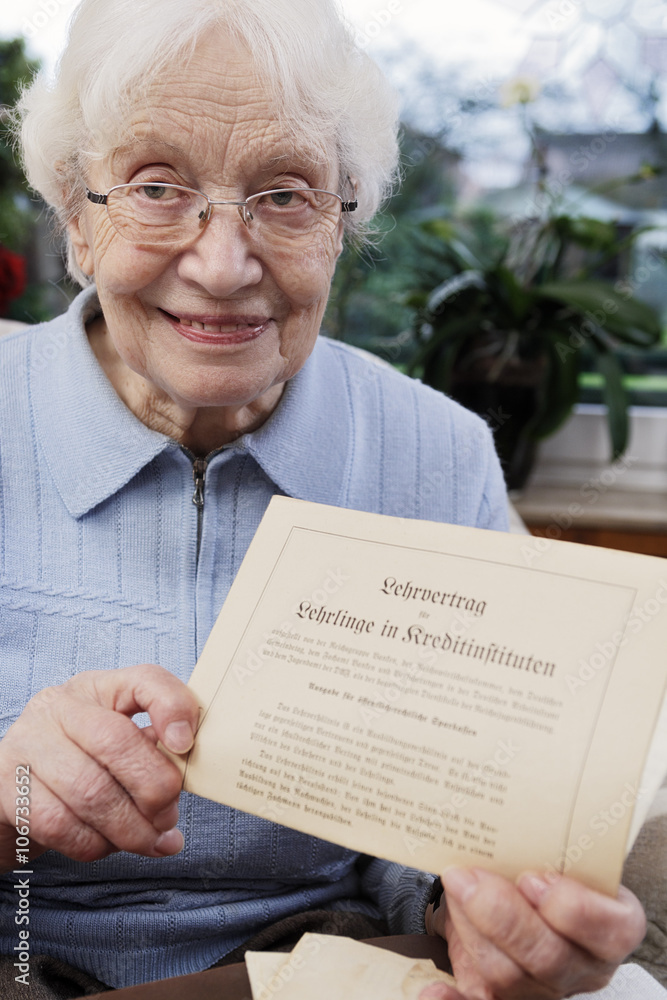 Senior women showing her old training contract Stock Photo | Adobe Stock