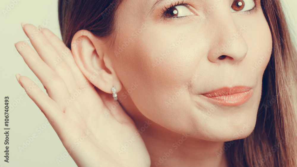 Gossip girl eavesdropping with hand to ear. Stock Photo | Adobe Stock