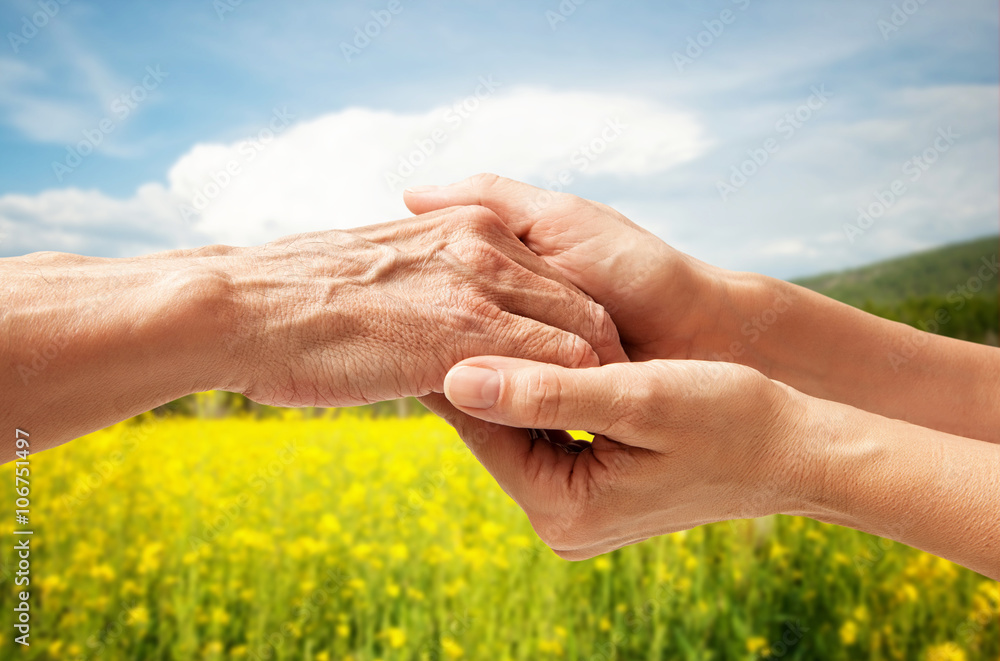 Hands of an elderly senior holding the hand of a woman Stock Photo ...
