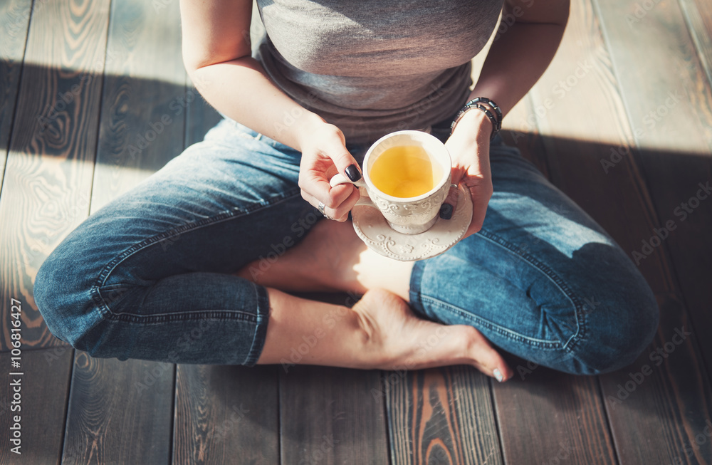 Cozy photo of young woman with cup of tea sitting on the floor Stock ...