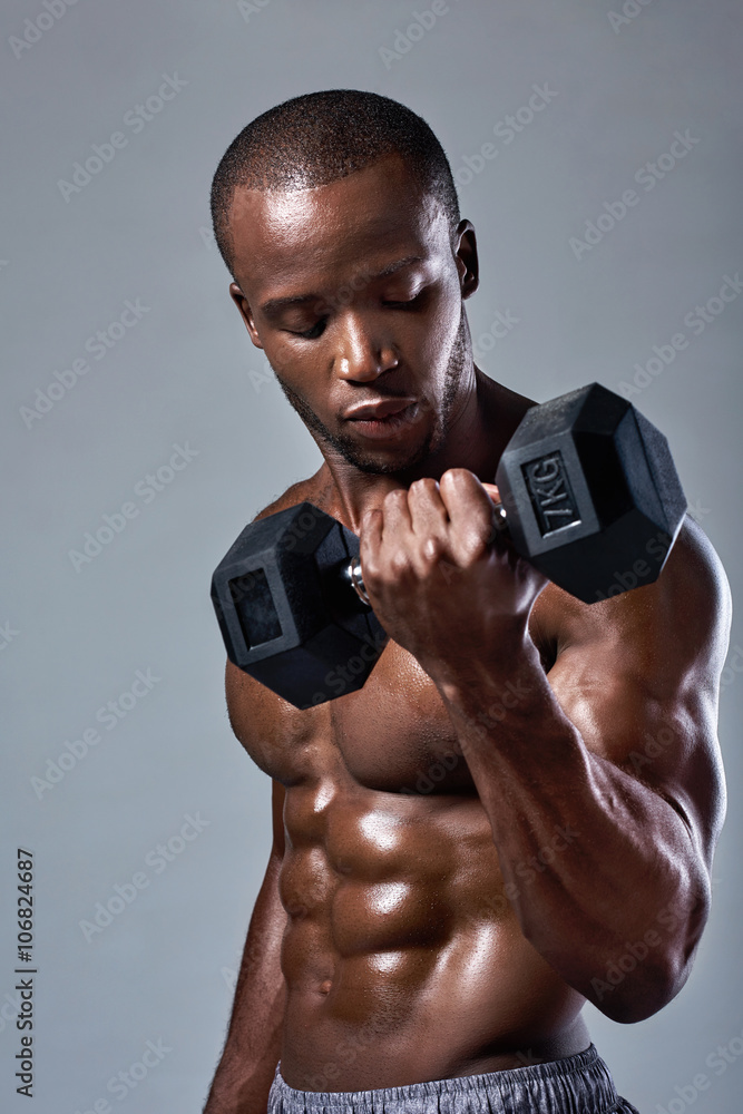 Fit strong black man with muscular body carrying weights isolated Stock ...