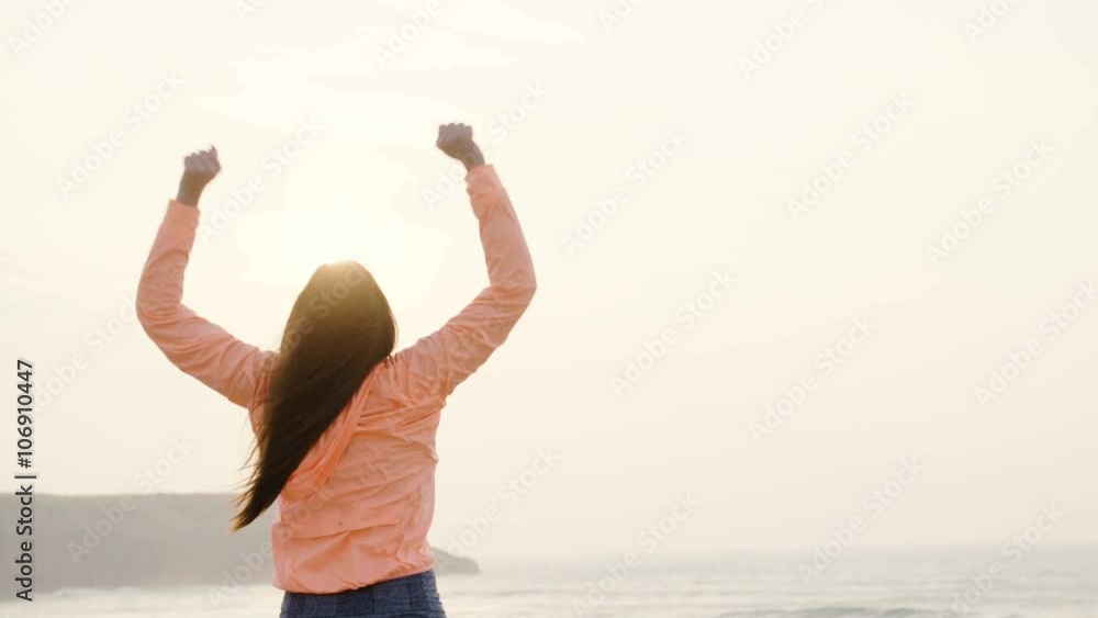 Happy woman raising arms for celebrating workout success and freedom ...