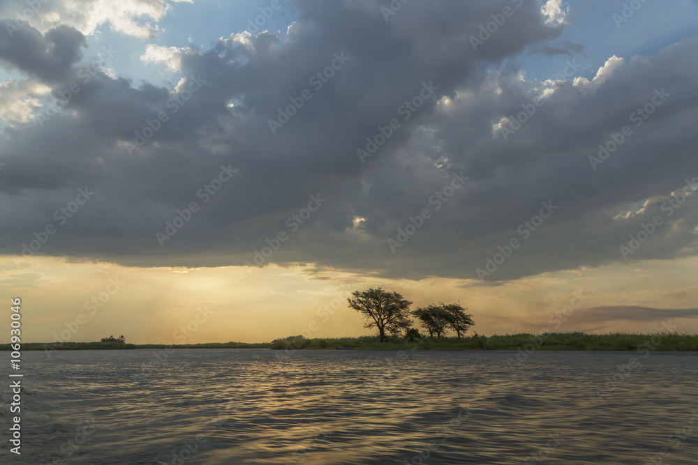 Water and silhouetted trees, Kasane, Chobe National Park, Botswana ...