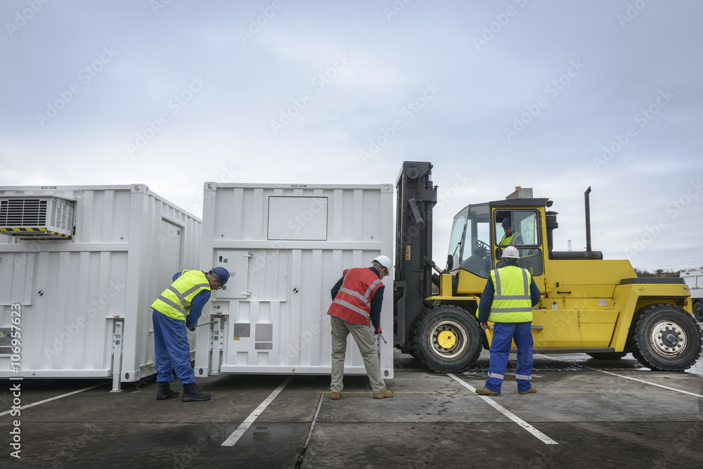Emergency Response Team workers installing emergency control rooms with ...
