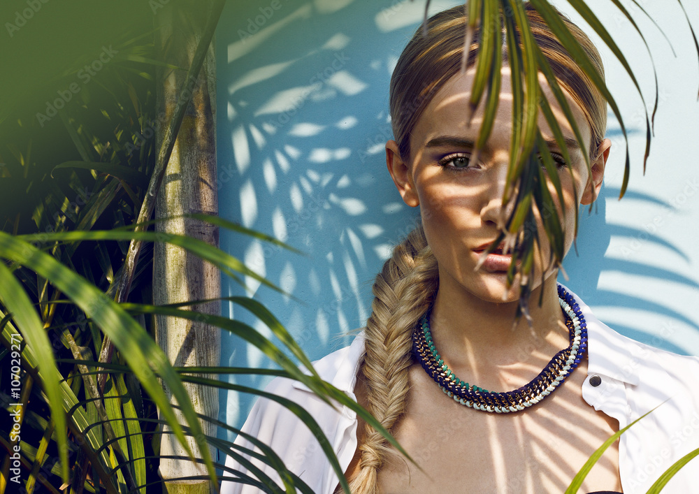 Close up of beautiful fashion model in the jungle scene, thinking while ...